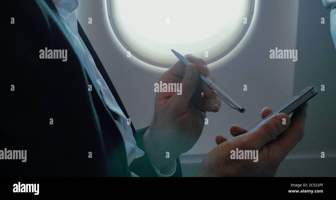 Businessman cell phone plane hi-res stock photography and images - Alamy