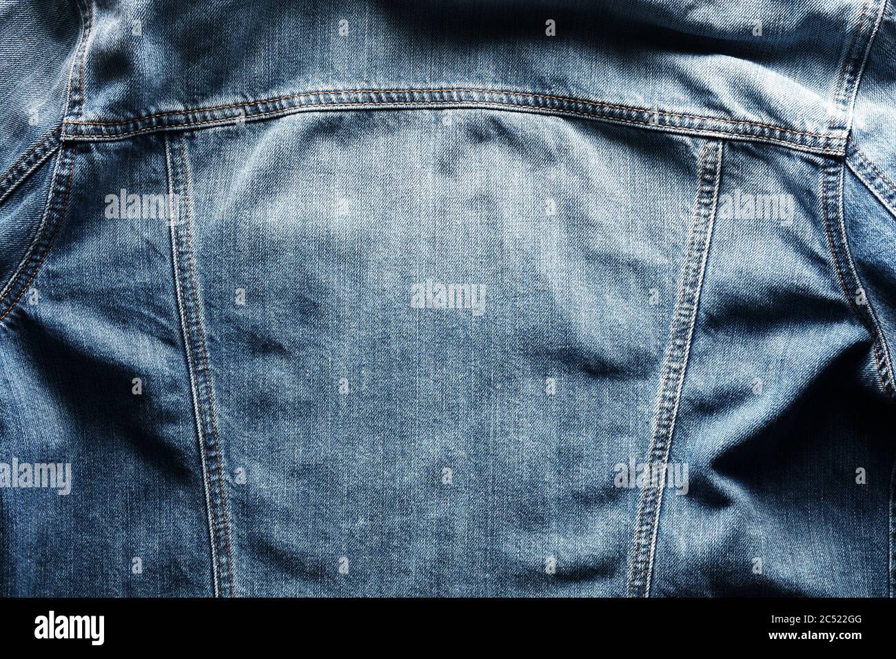 Back side of a vintage blue jeans or denim jacket with copy space ...