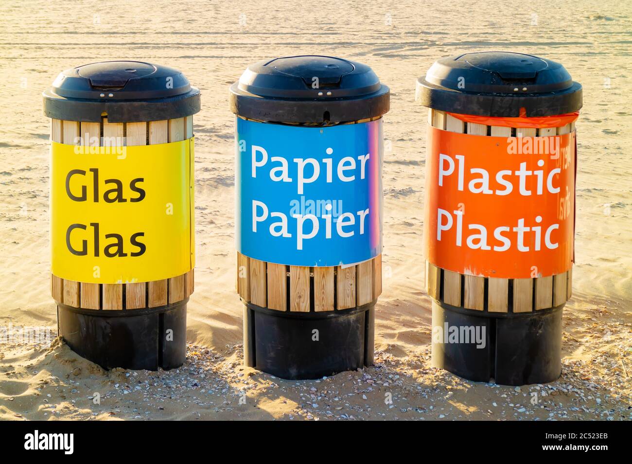 Dutch recycle waste bins for glass, paper and plastics on a beach Stock ...