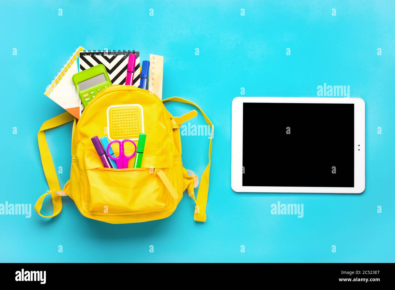 Back to school, education concept. Yellow backpack with school supplies ...