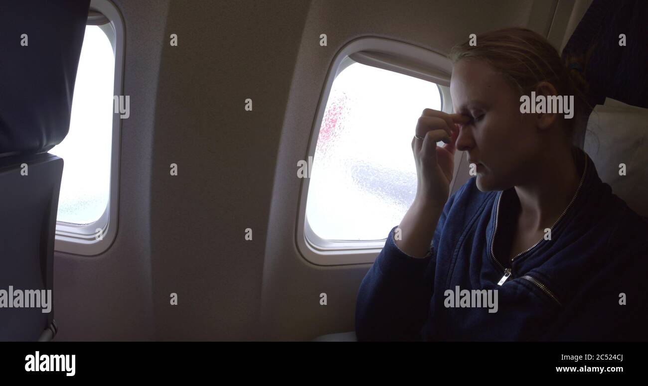 Woman in the plane feeling sick Stock Photo - Alamy