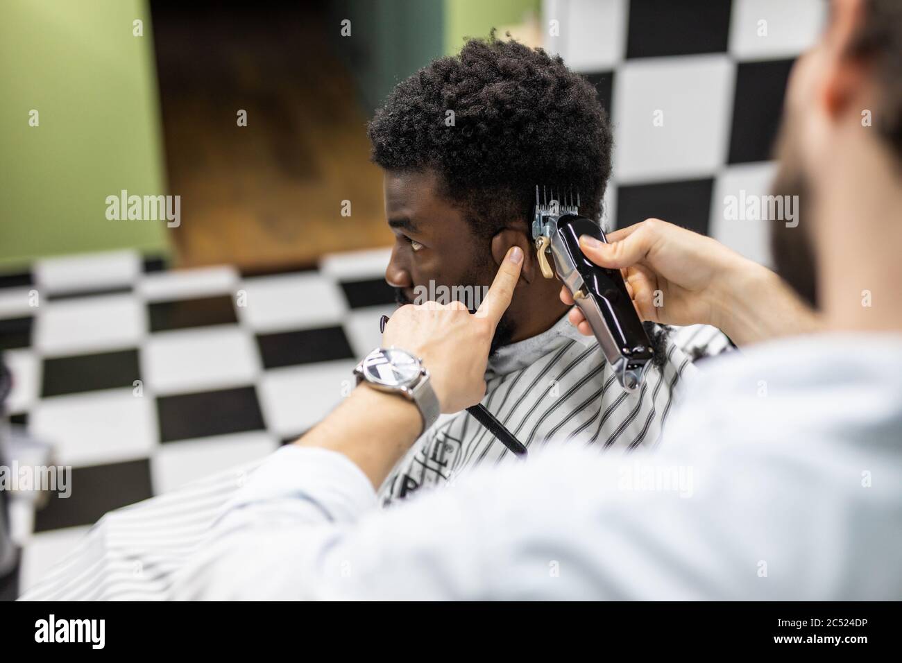 Closeup of process of trimming of hair in barber shop. Qualified barber ...