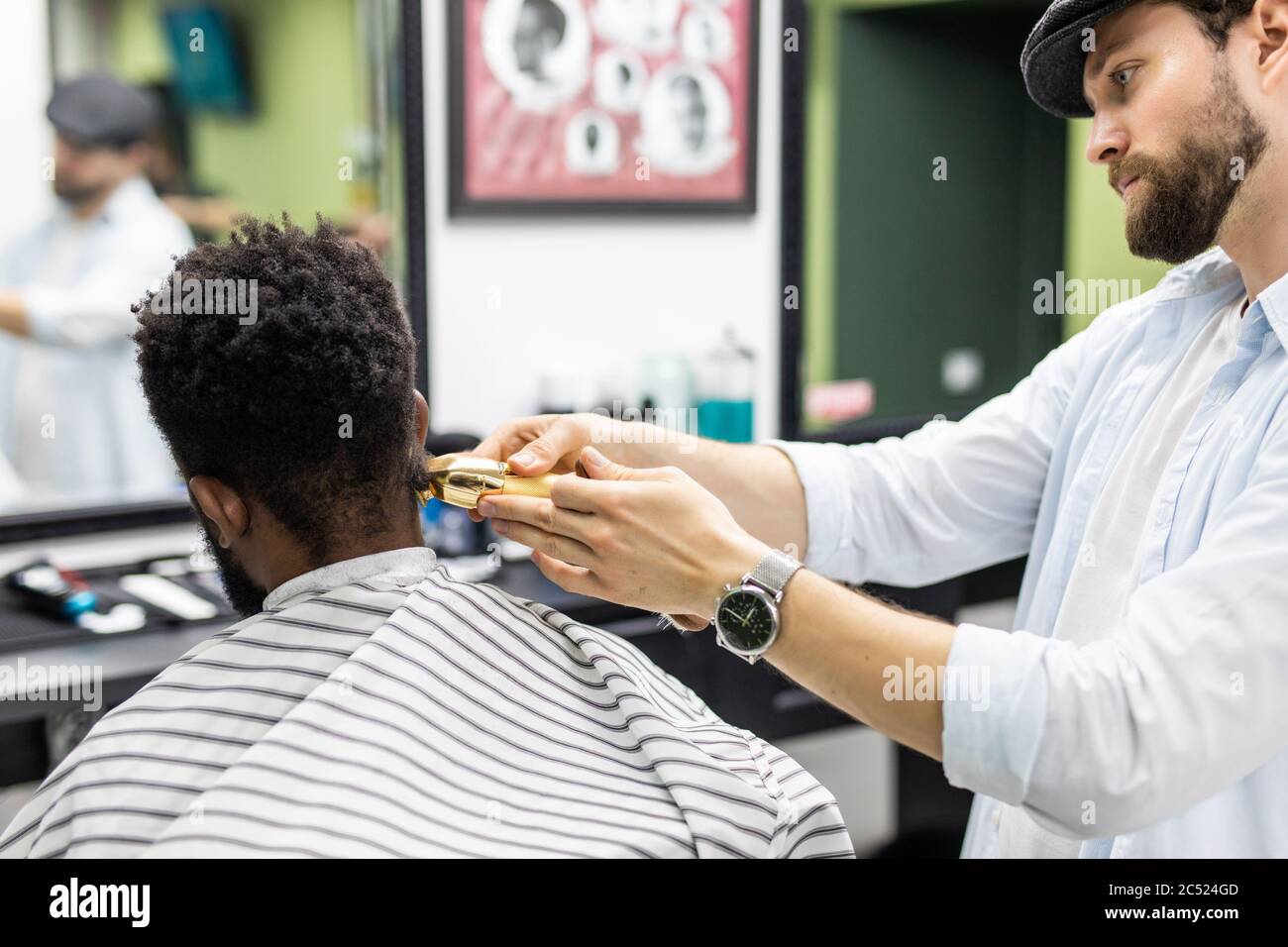 Closeup of process of trimming of hair in barber shop. Qualified barber ...