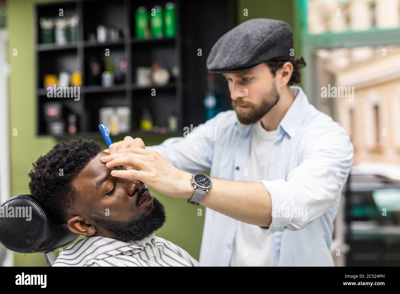 Side view of serious man with stylish modern haircut looking forward in ...