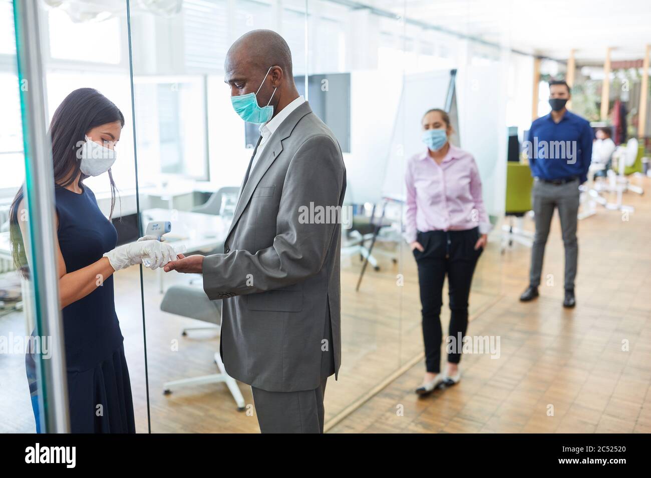 Business people screening for covid-19 as a precaution measure with ...