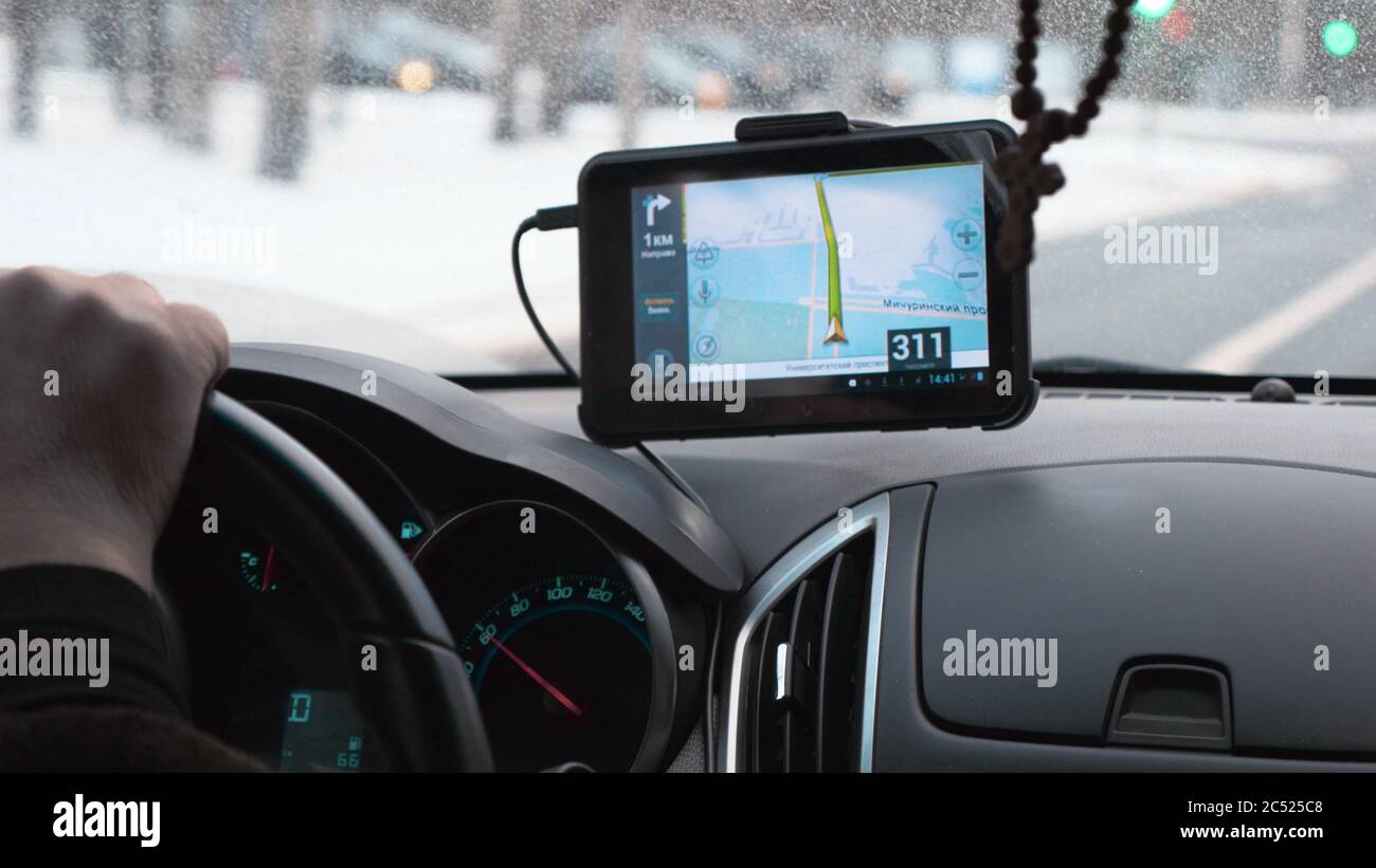 Close-up shot of car driving with GPS device over the dashboard showing ...