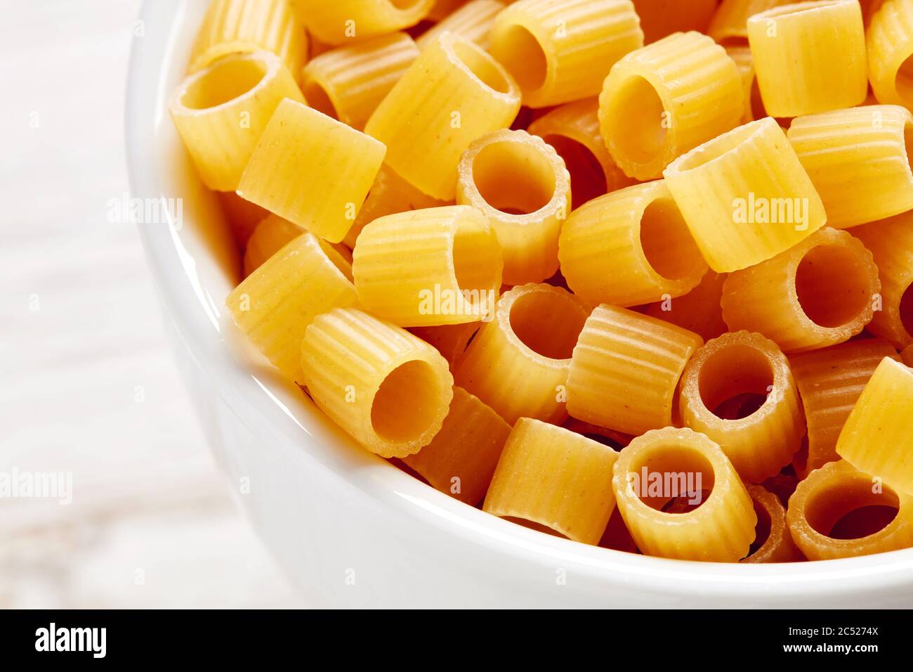 Heap of raw ditalini pasta in a white bowl. Macro close up view Stock ...