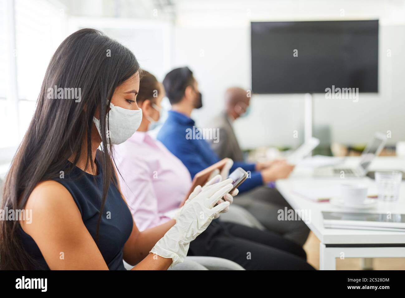 Business woman wearing face mask because of Covid-19 using smartphone ...