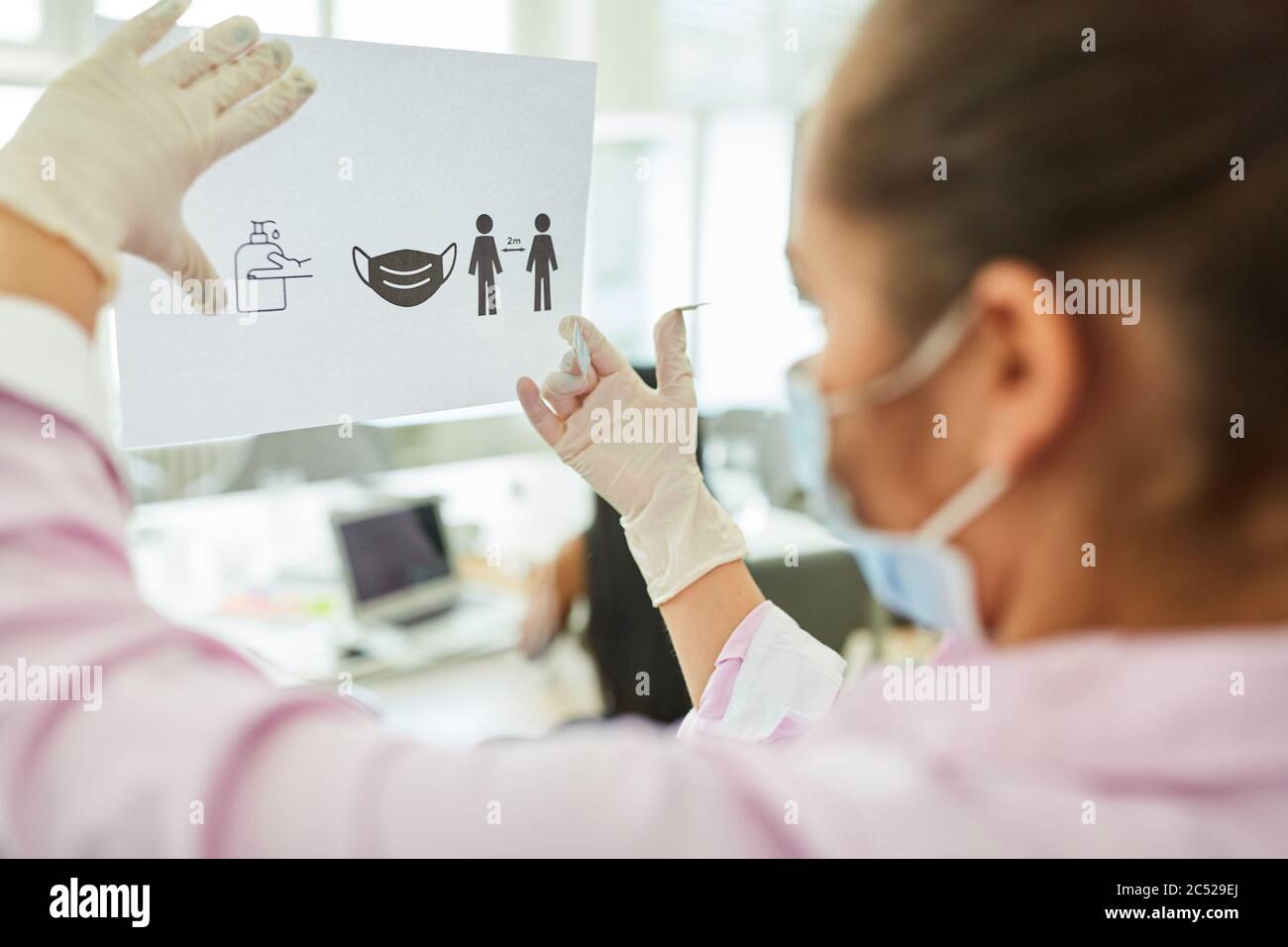 Business woman hangs information with hygiene rules on infection ...