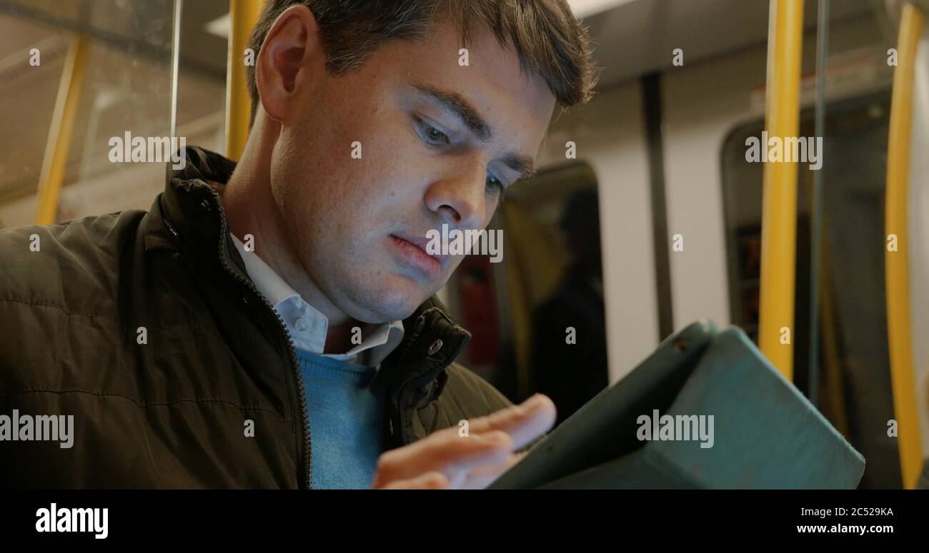 Man Using Tablet PC in Metro Train Stock Photo - Alamy
