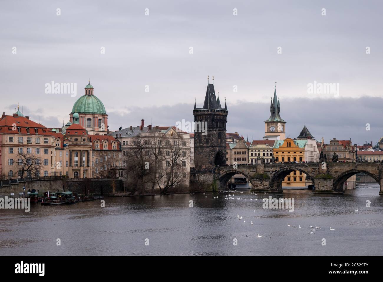 Beautiful sunset on a cold day in Prague. Views of a bridge and ancient ...