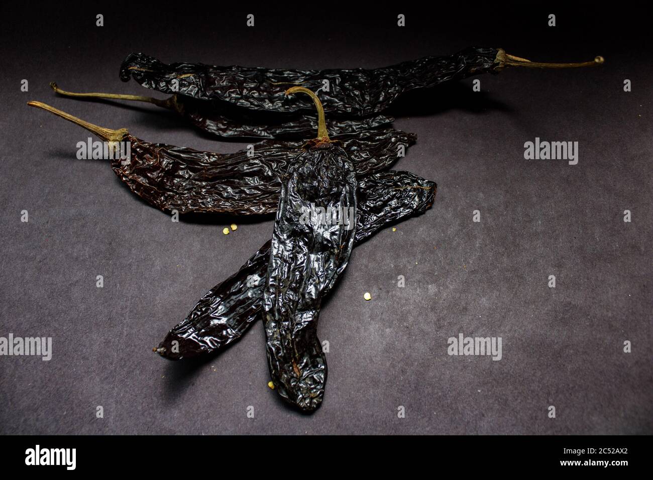 Dried Mexican black chili pepper for the spicy sauce Stock Photo - Alamy