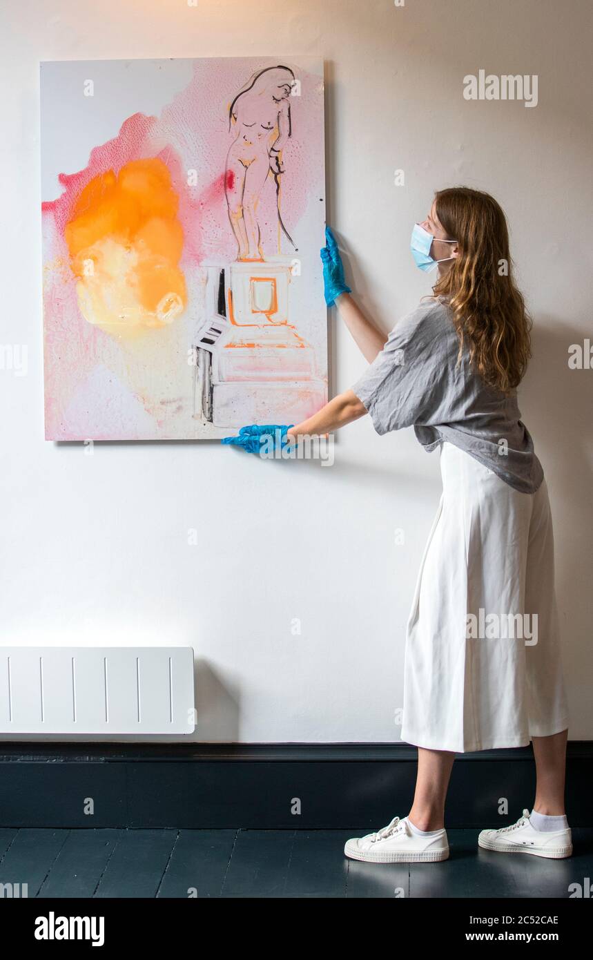 Curatorial assistant Alexandra Marchant Wink hangs a new piece titled ...