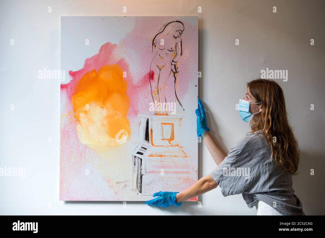 Curatorial assistant Alexandra Marchant Wink hangs a new piece titled ...