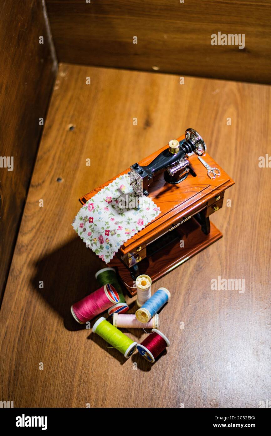 Overhead shot of a small sewing machine and colorful threads Stock ...