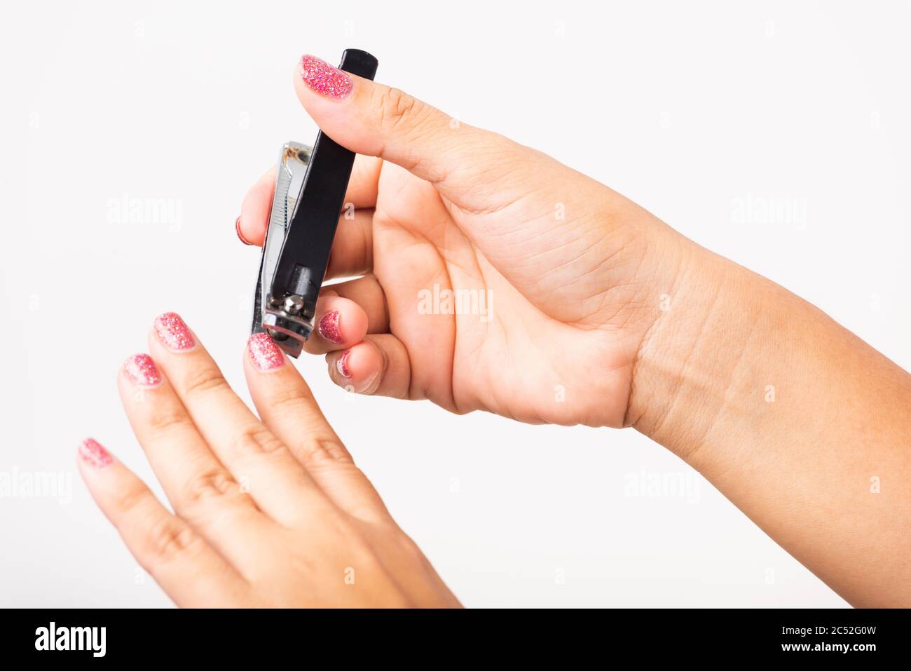 Close up young Asian woman have tool cutting nails fingernails on ...