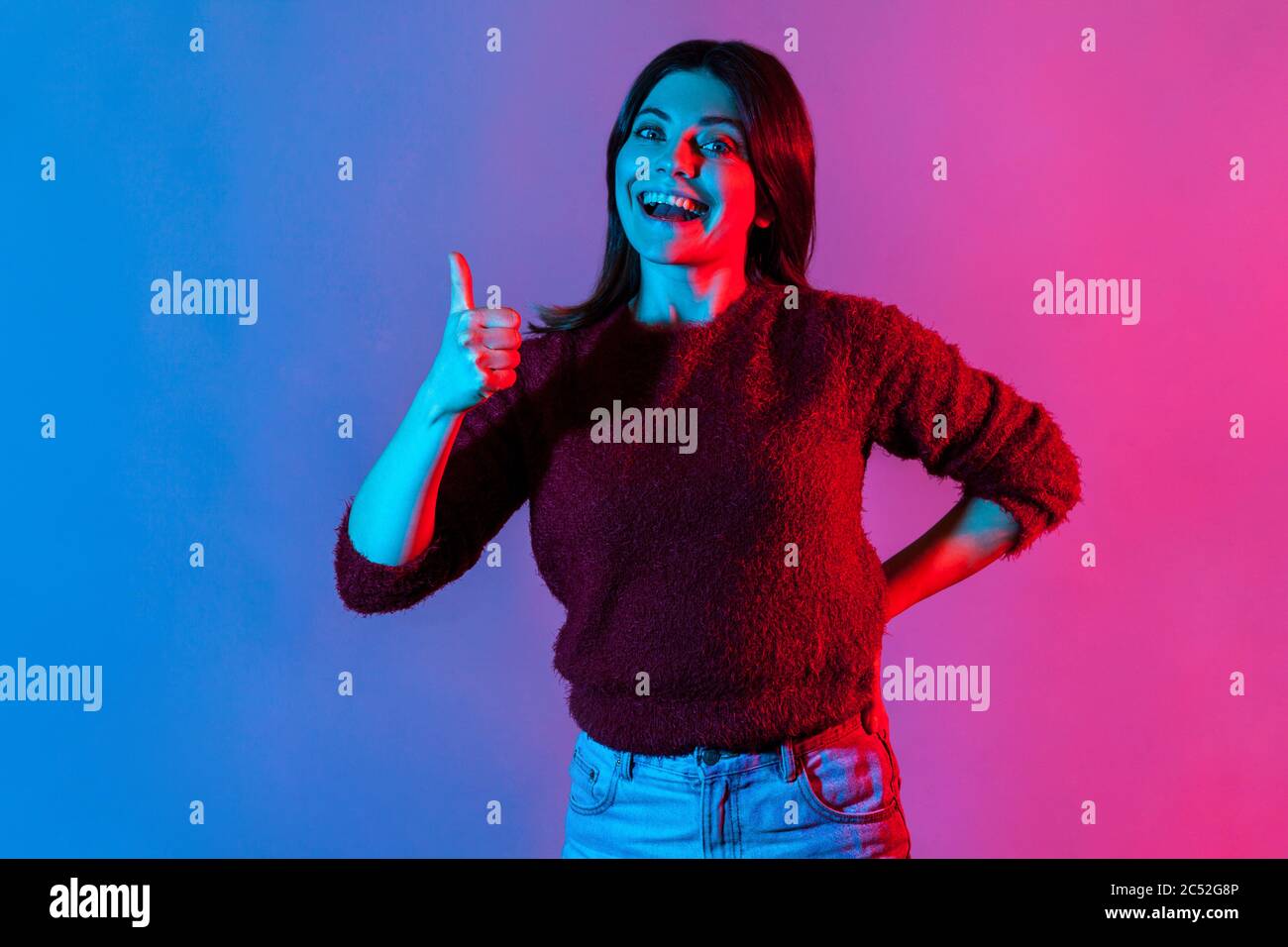 Well done, good job! Neon light portrait of joyful brunette woman ...