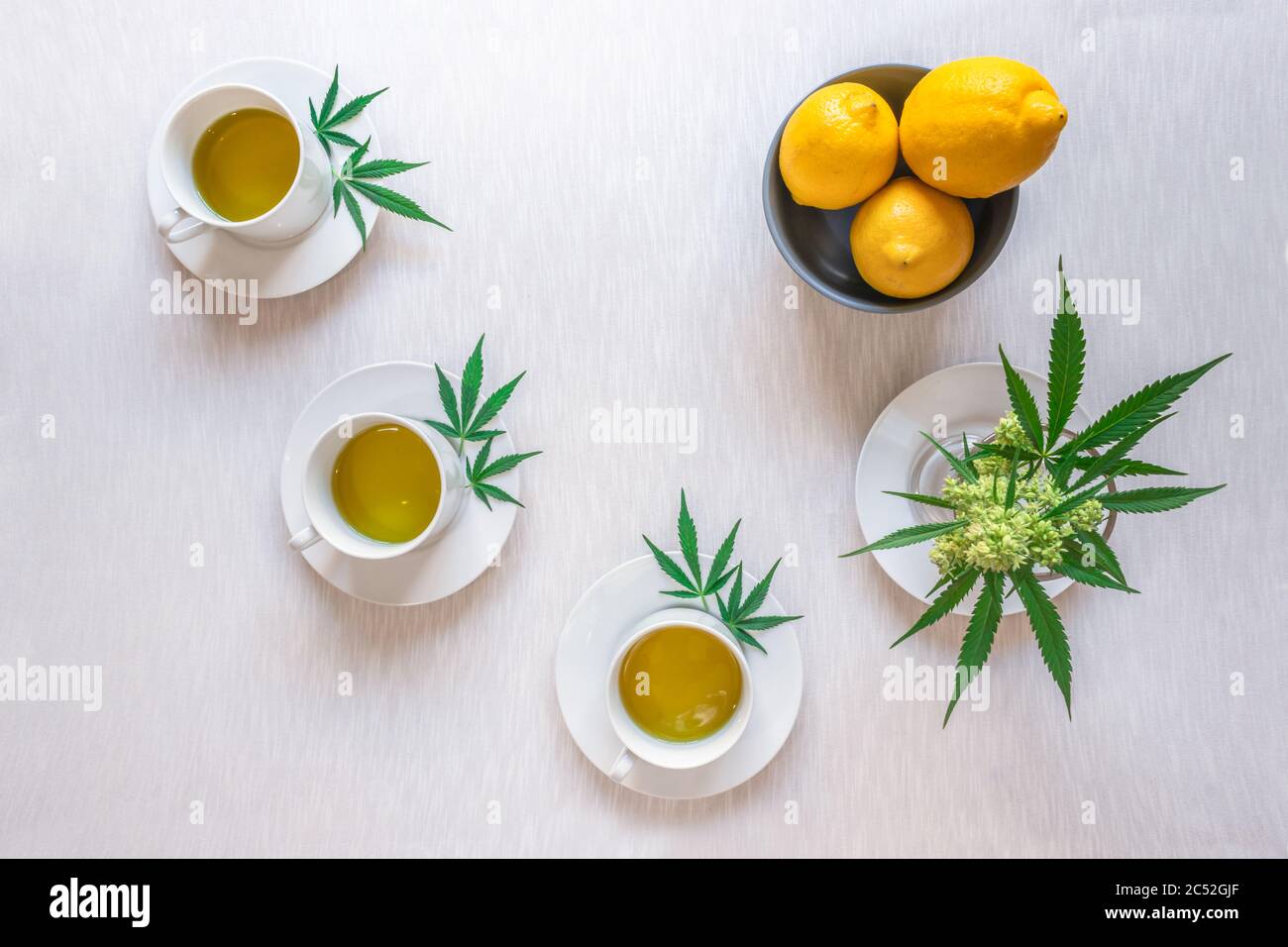 A Cannabis (hemp) and lemon tea beverage in mugs ready to consumed ...