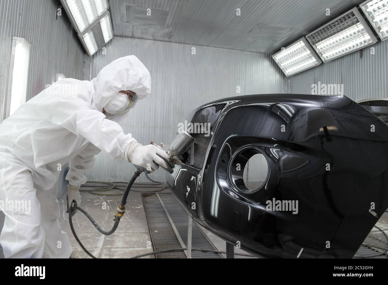 Mechanic respraying a car in a garage Stock Photo - Alamy