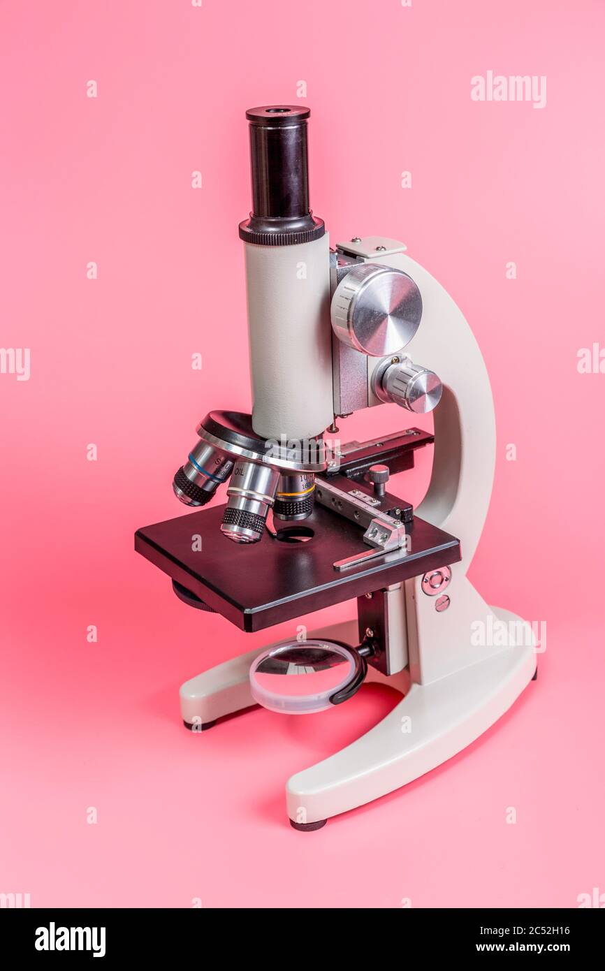 Metal microscope on pink base Stock Photo - Alamy
