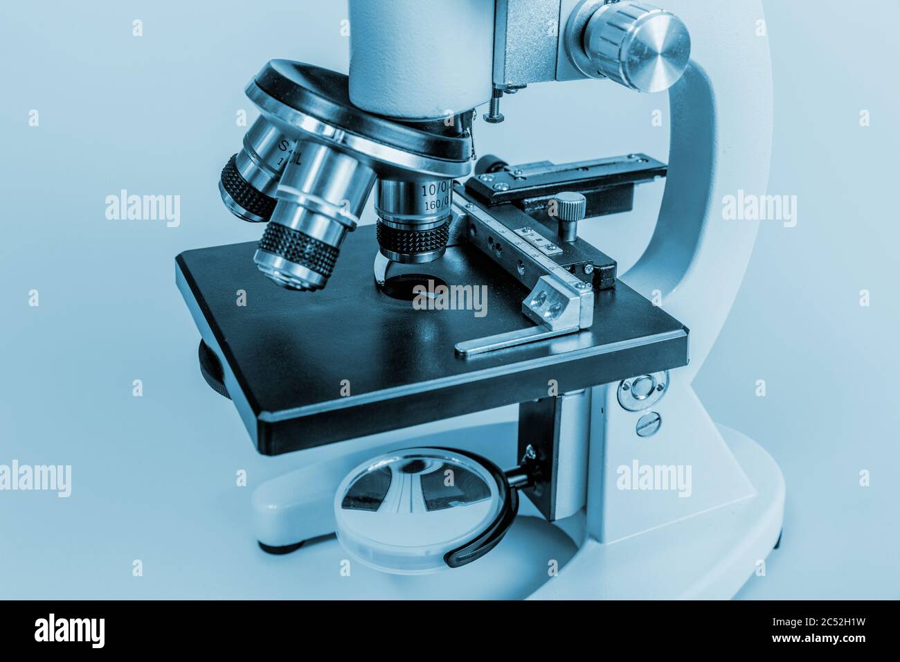 Metal microscope on blue background Stock Photo - Alamy