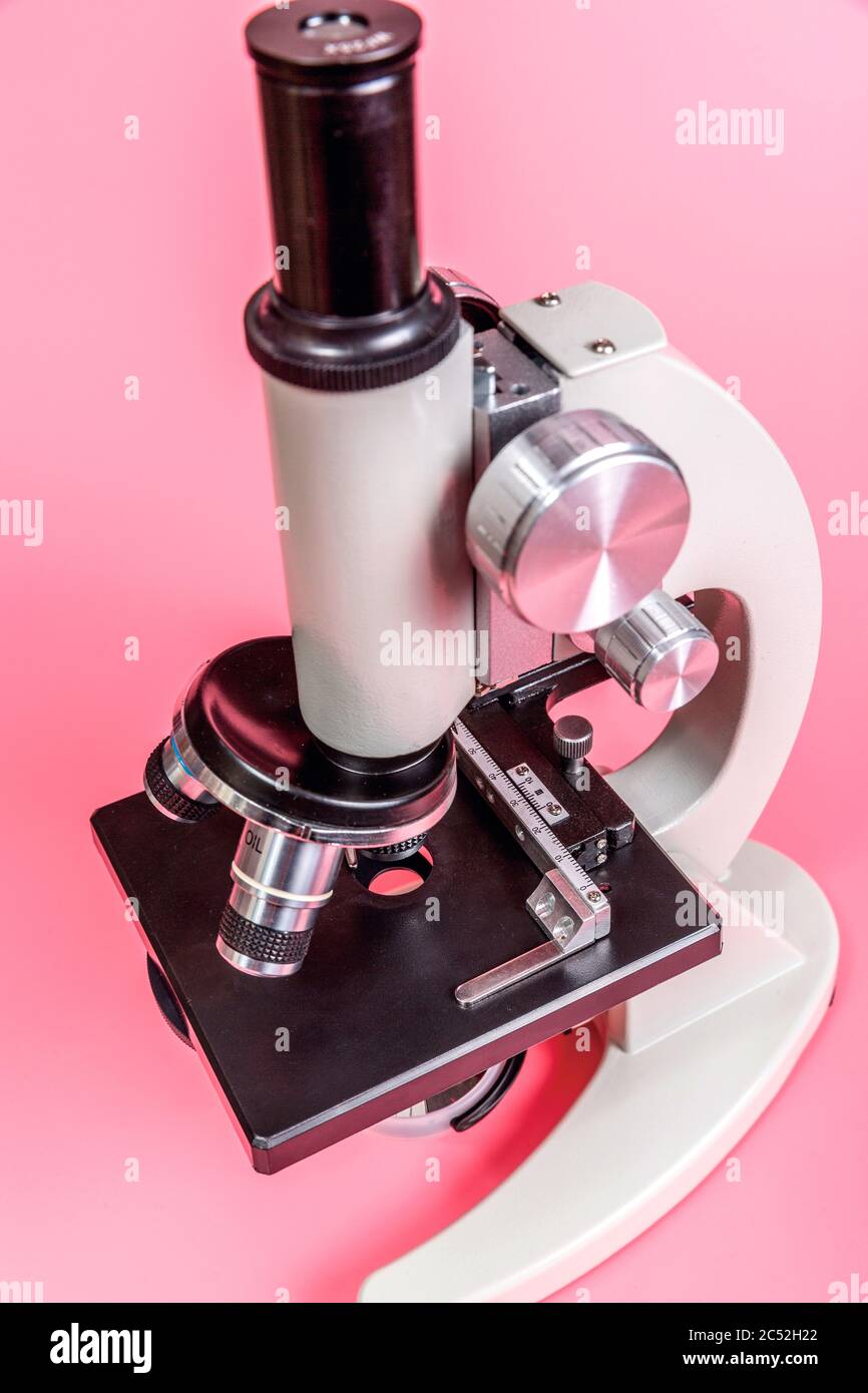 Metal microscope on pink base Stock Photo - Alamy