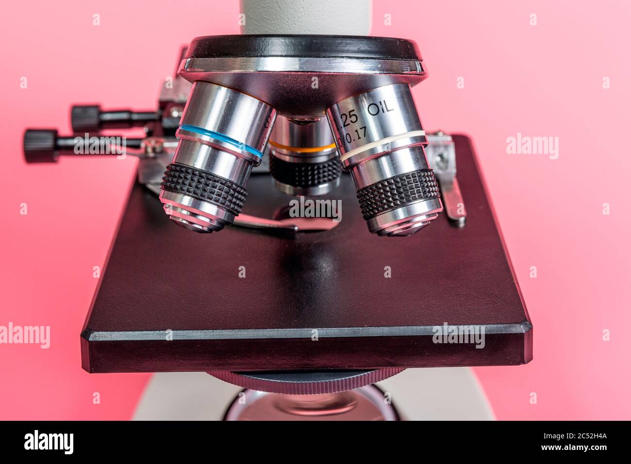 Metal microscope on pink base Stock Photo - Alamy