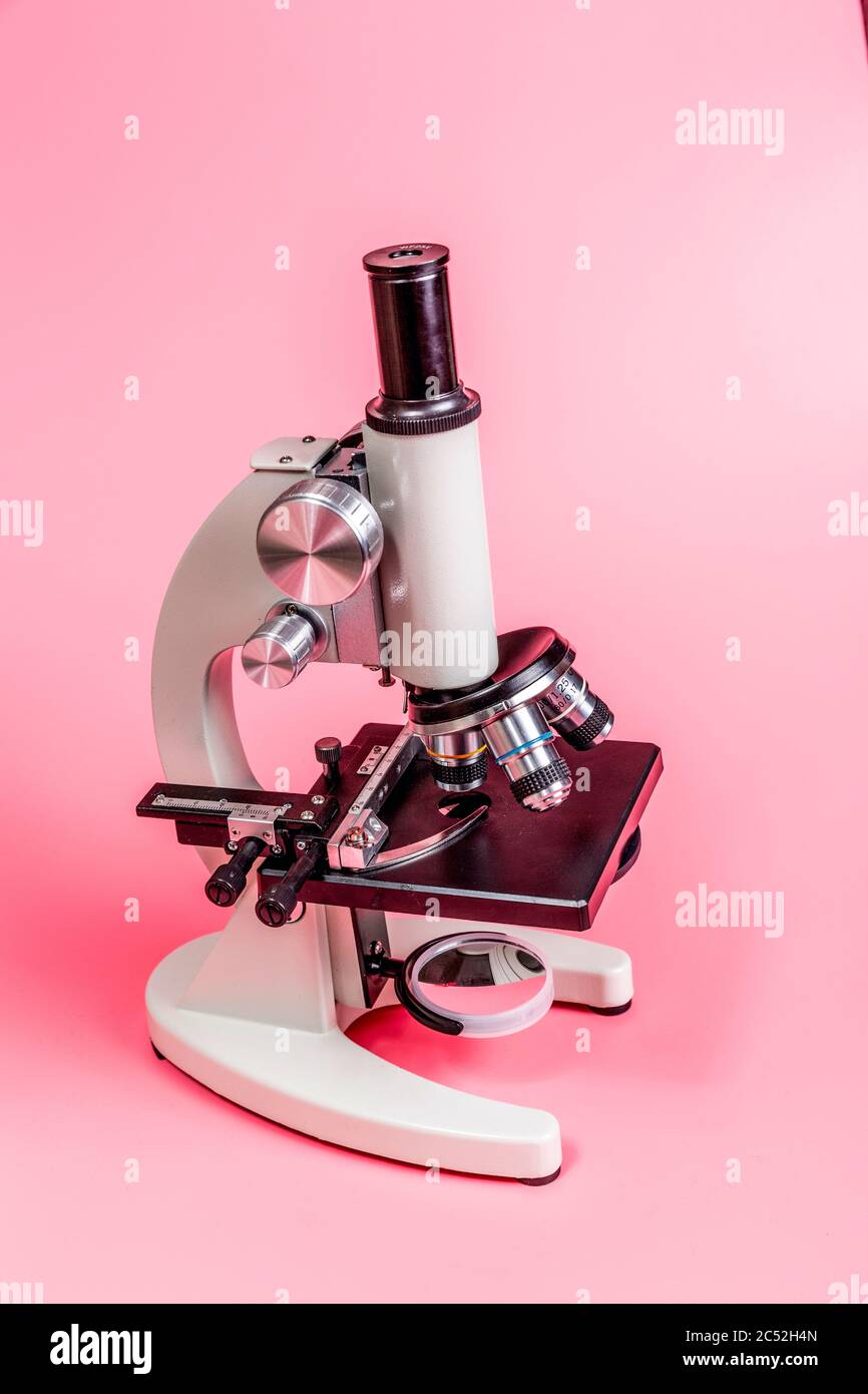 Metal microscope on pink base Stock Photo - Alamy
