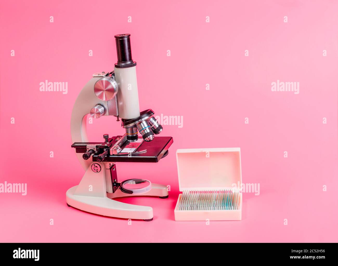 Metal microscope on pink base Stock Photo - Alamy