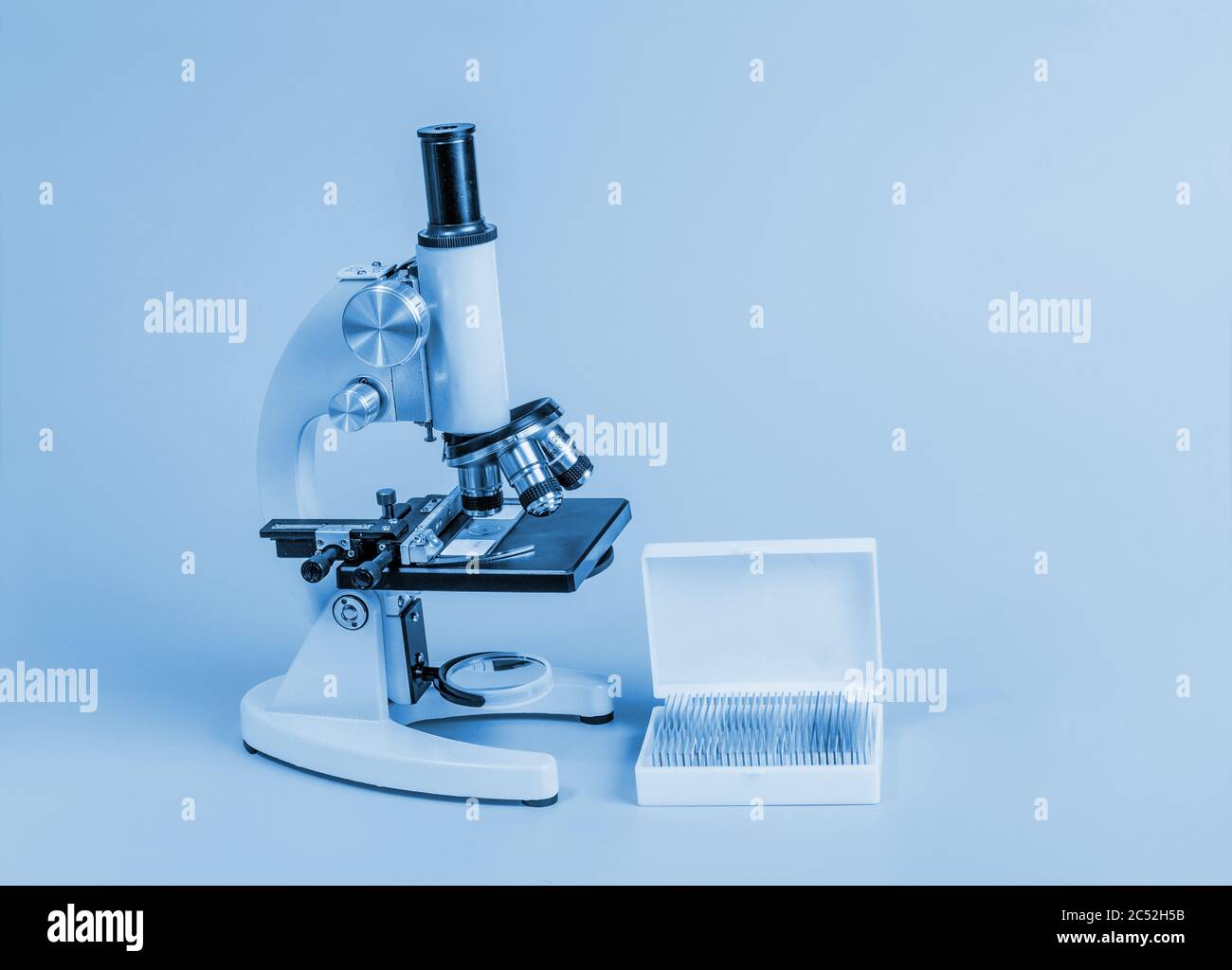 Metal microscope on blue background Stock Photo - Alamy