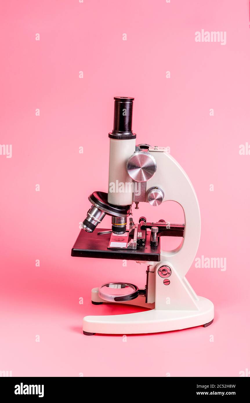 Metal microscope on pink base Stock Photo - Alamy