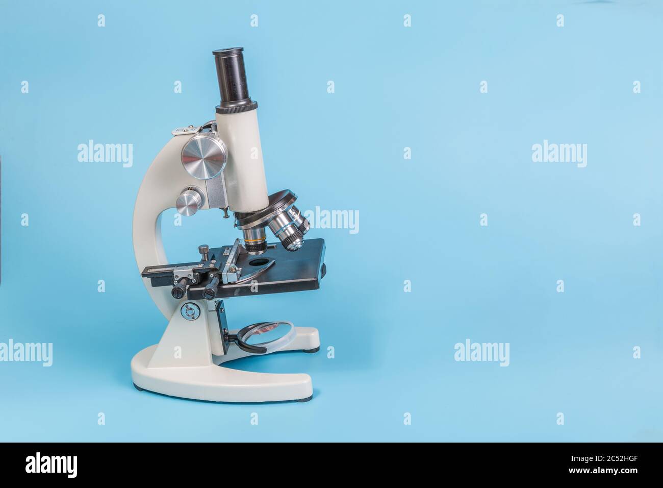 Metal microscope on blue background Stock Photo - Alamy