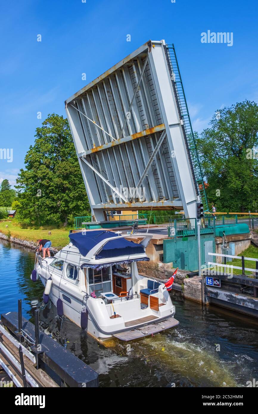 Motor boat at a bridge opening in a canal Stock Photo - Alamy