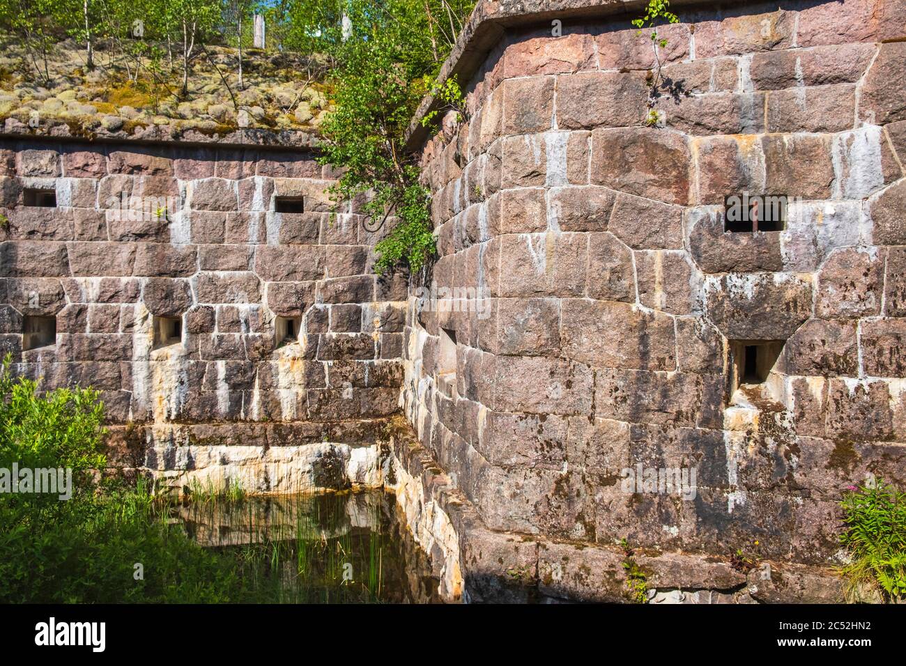 Old fortified wall in moat with water Stock Photo - Alamy