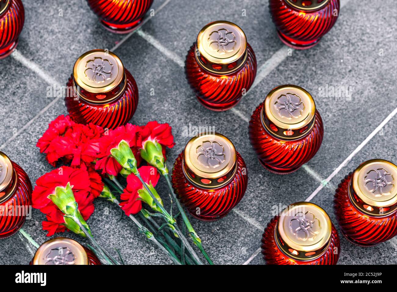 Carnations on a marble slab and funeral lamps Stock Photo - Alamy