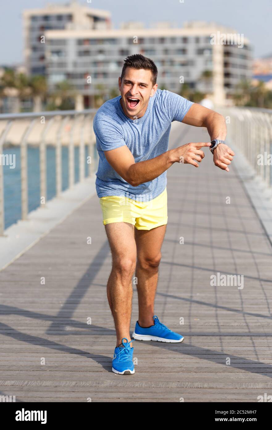 Athlete man checking fitness results on sport tracker wristband after ...