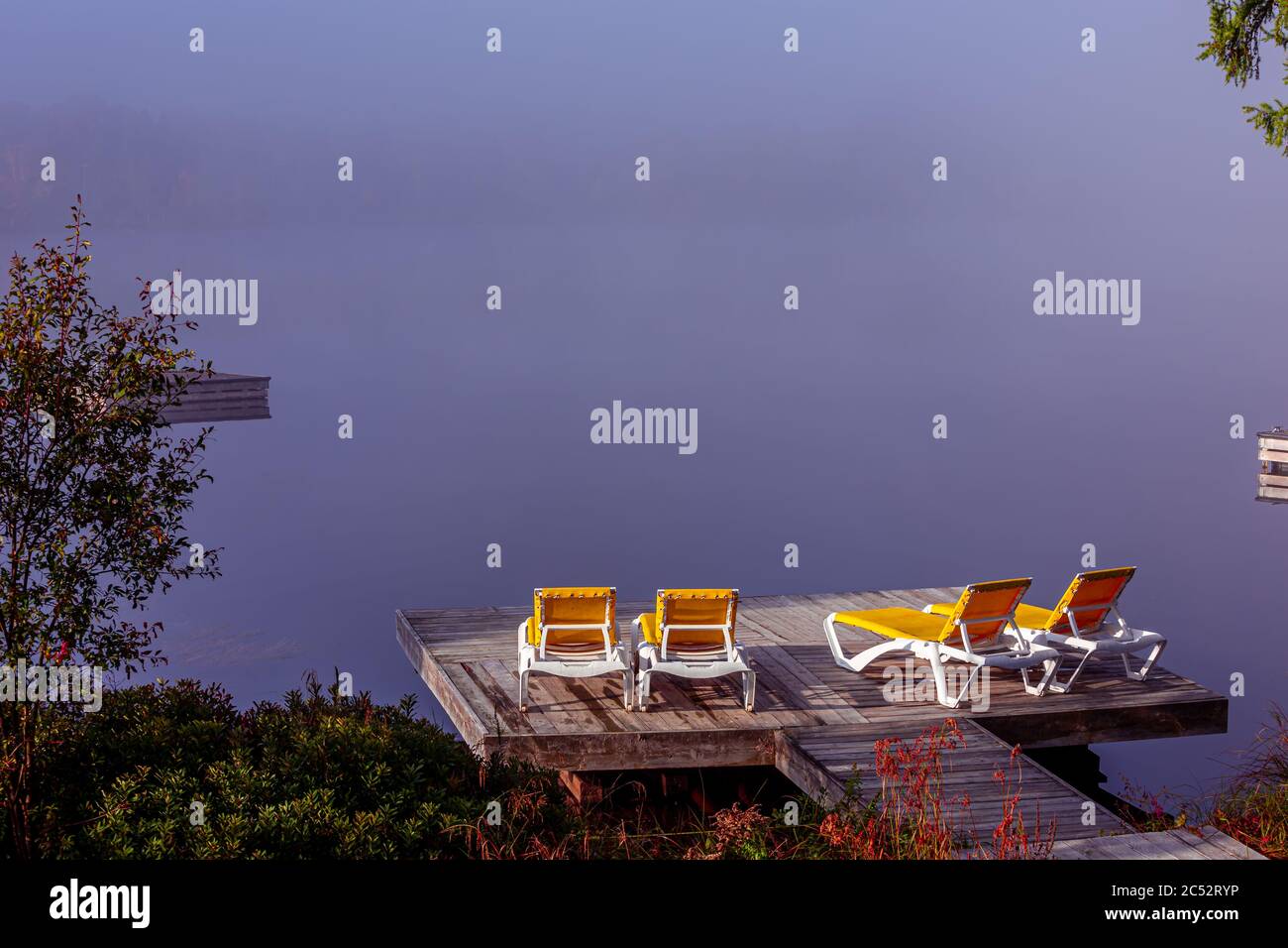 view of a boat dock the Lac-Superieur, misty morning with fog, in ...