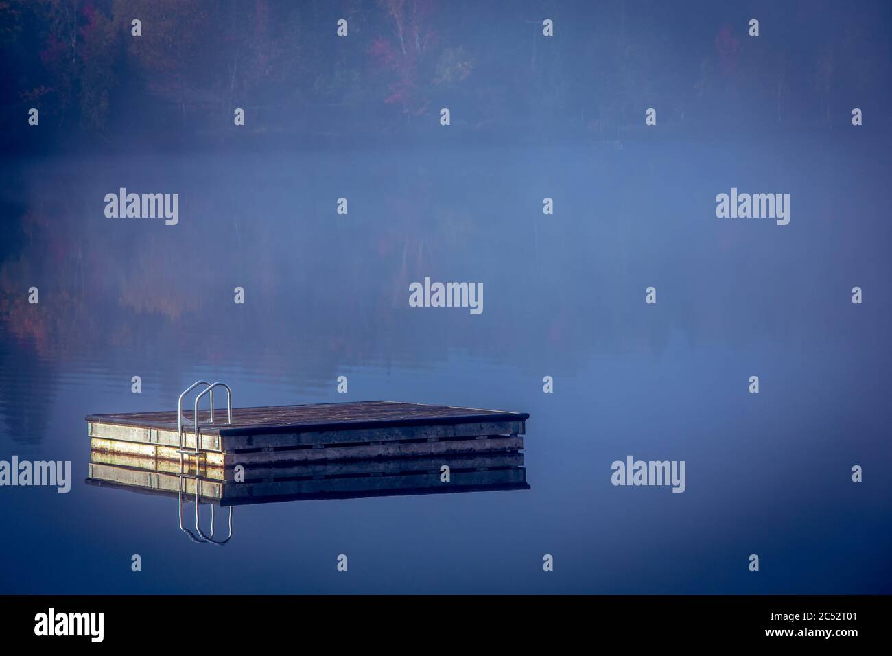 view of a boat dock the Lac-Superieur, misty morning with fog, in ...