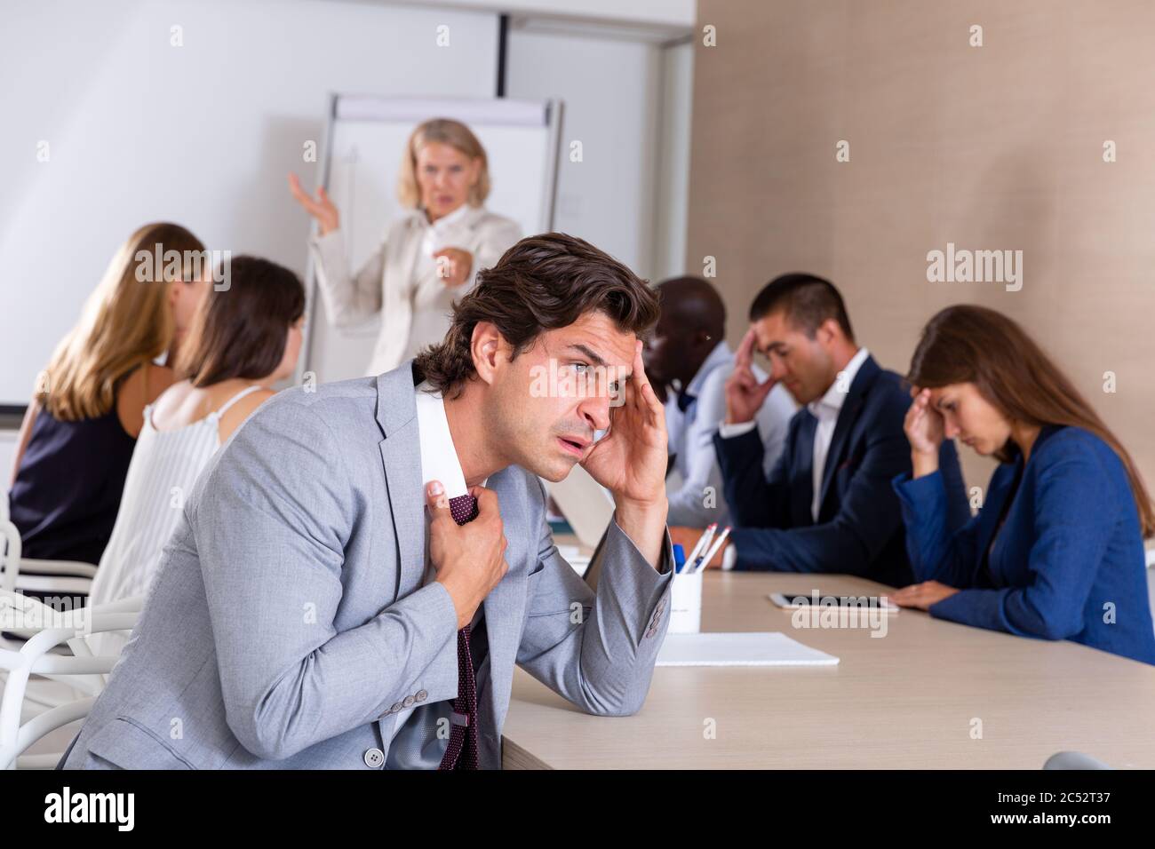 Portrait of sad and tired adult businessman on meeting in office Stock ...