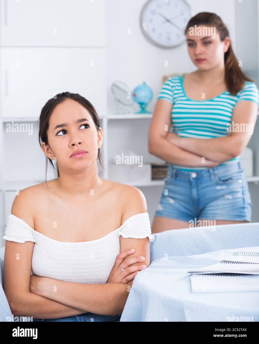 Two upset friends not talking to each other after fight on the sofa ...