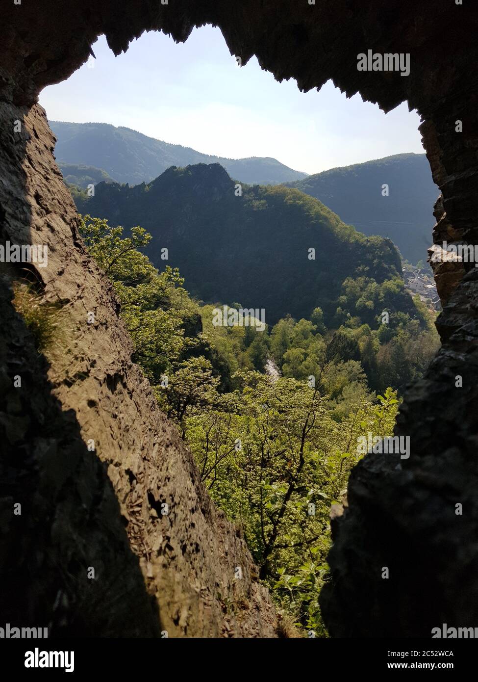Vertical beautiful mountain forest view from a cave Stock Photo - Alamy