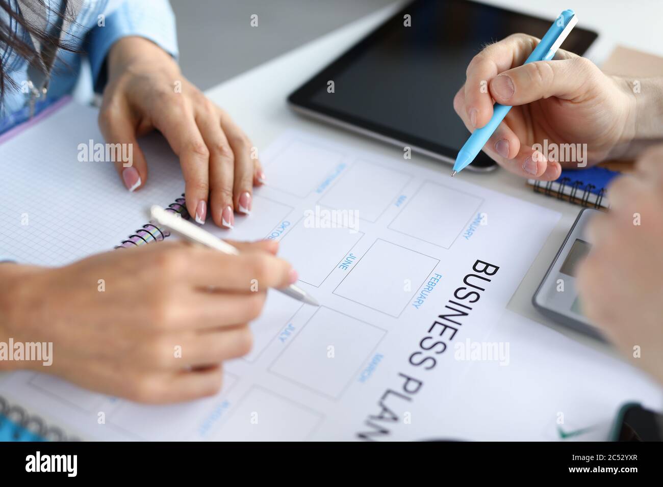 People in office with pens Stock Photo - Alamy