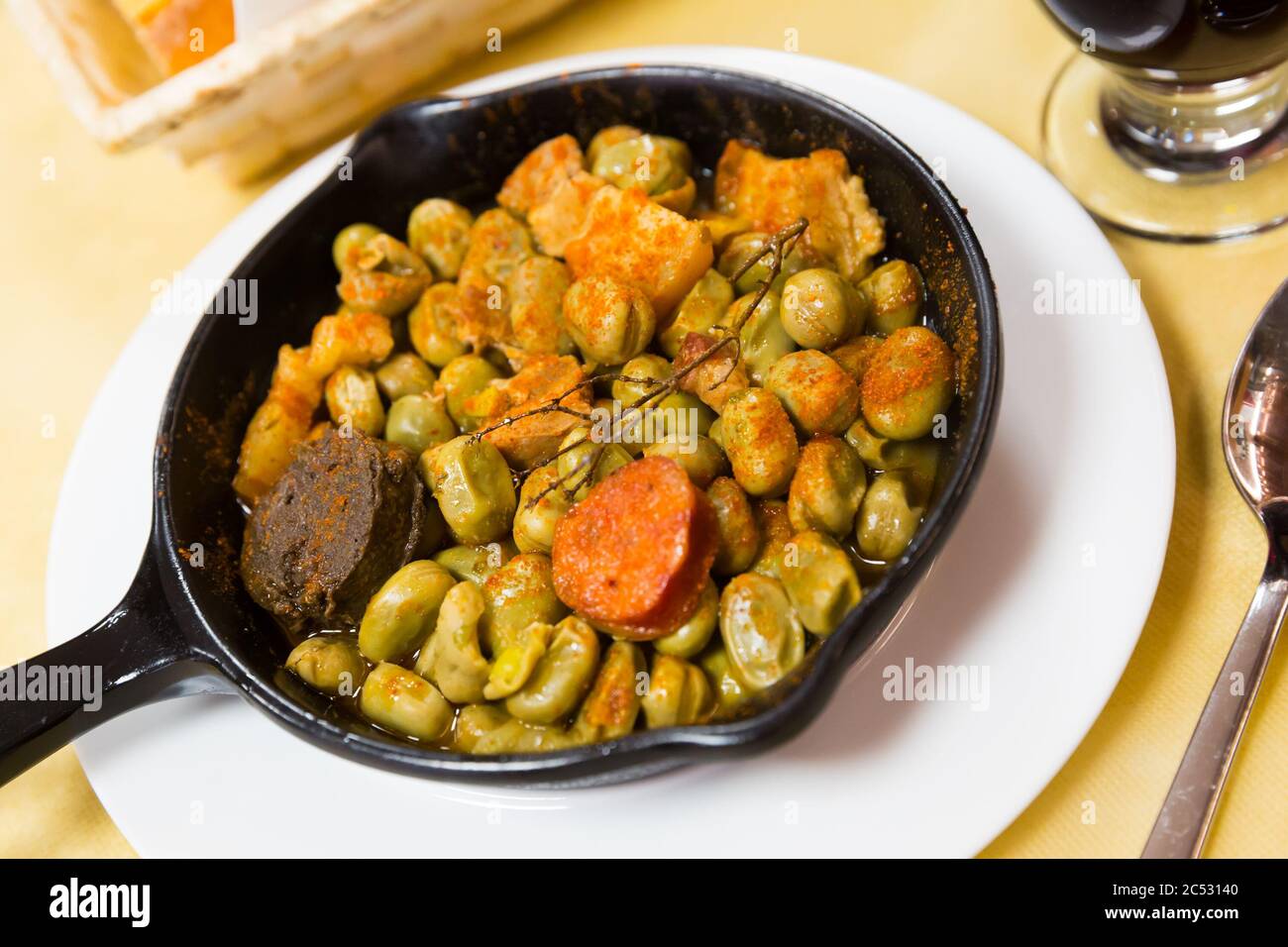 Popular Catalan style beans cooked with sliced blood sausage, chorizo ...