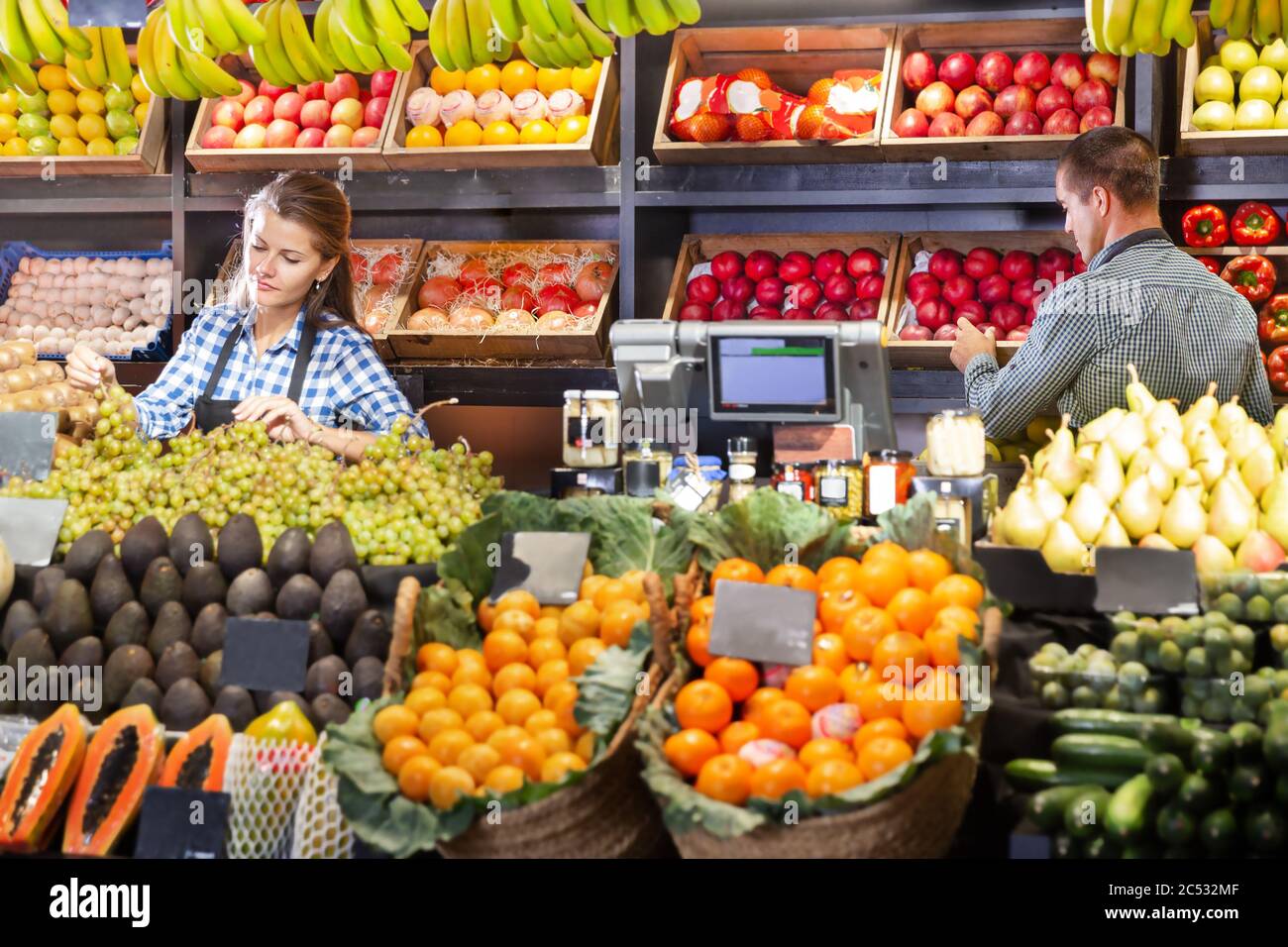 Portrait of male and female shop assistants working responsibly at the ...