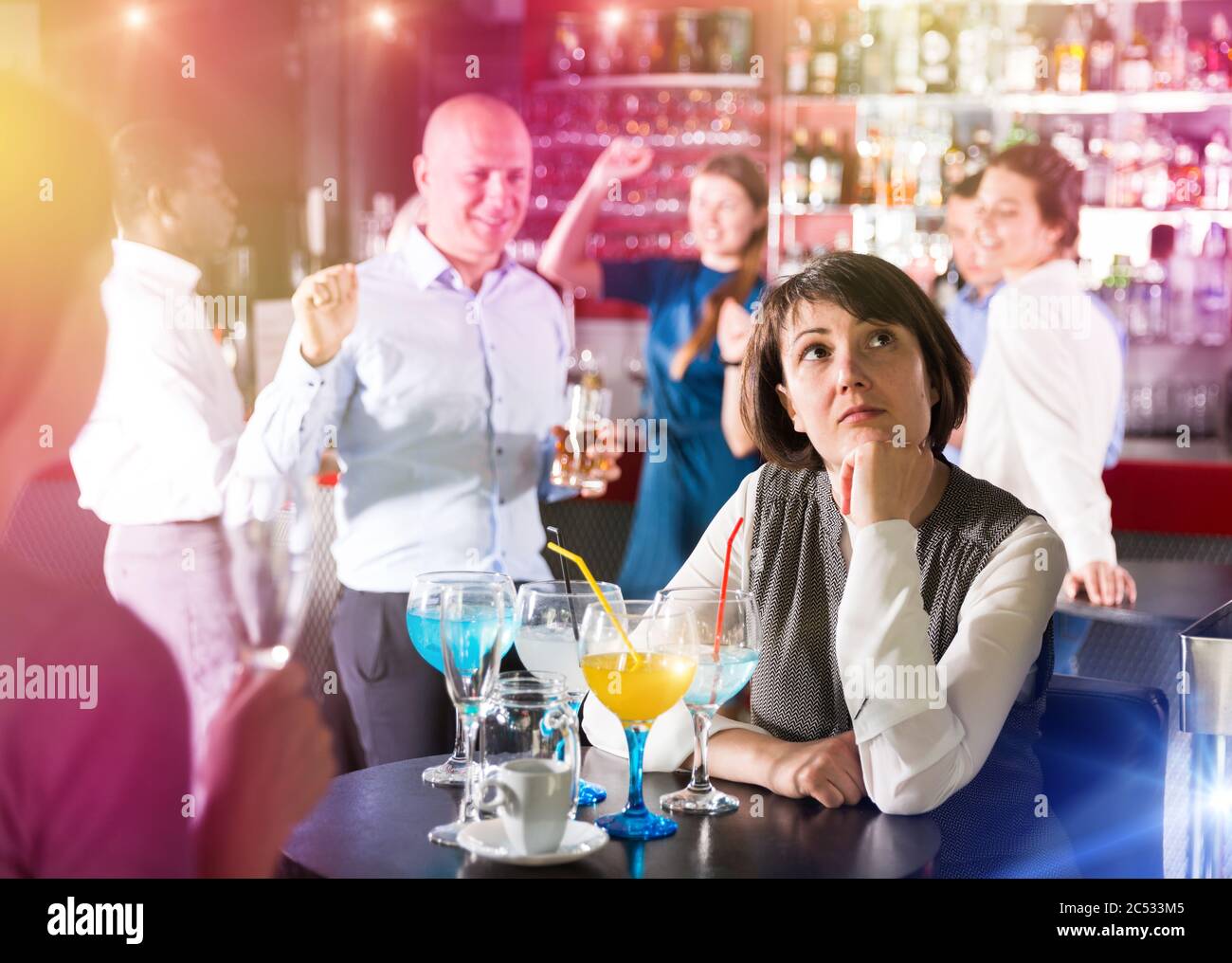 Portrait of sad woman bored at corporate party Stock Photo - Alamy