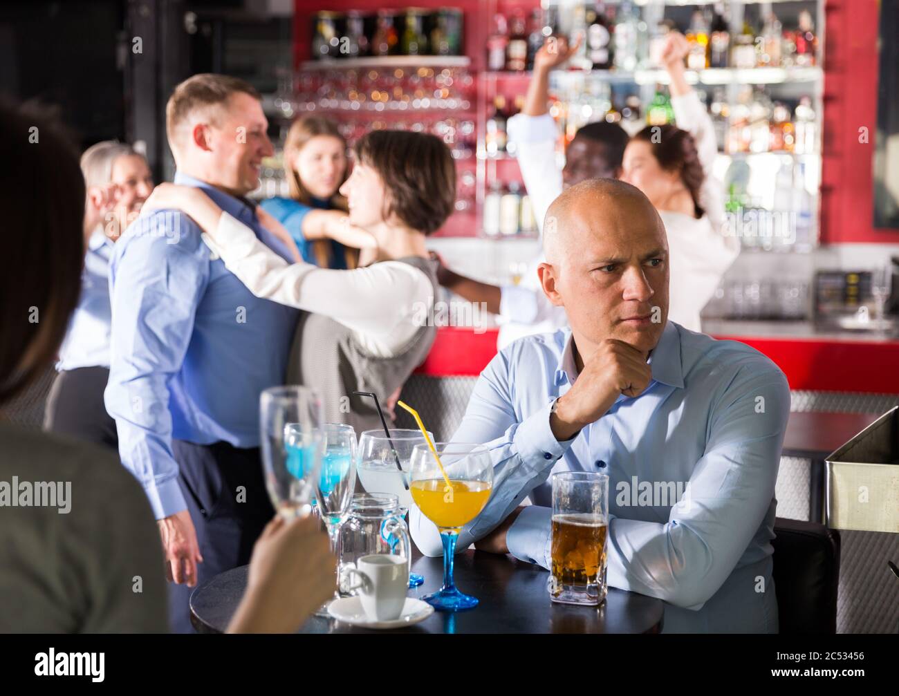 Portrait of sad bored man at corporate party Stock Photo - Alamy