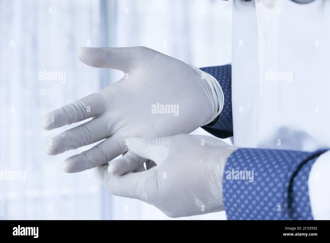Doctor wears medical latex gloves hi-res stock photography and images ...