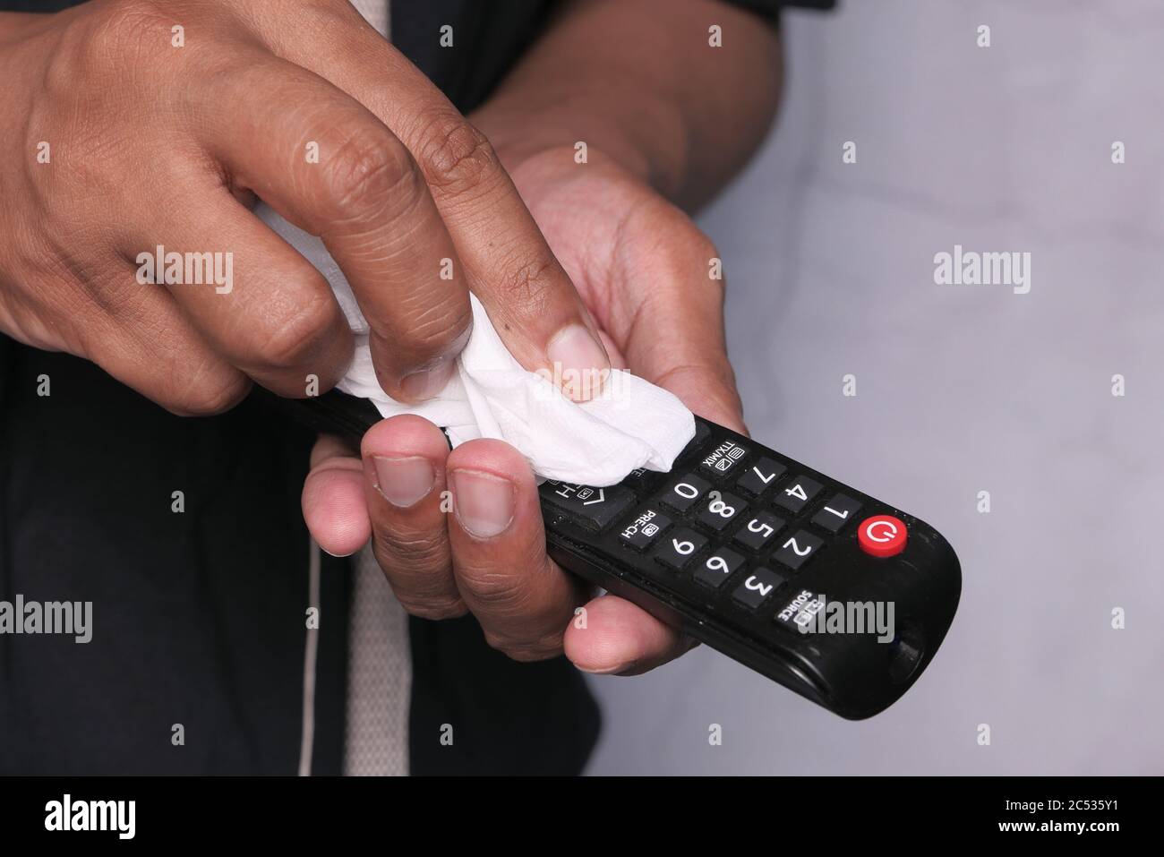 Cleaning Tv remote control with an antibacterial fabric tissue Stock ...