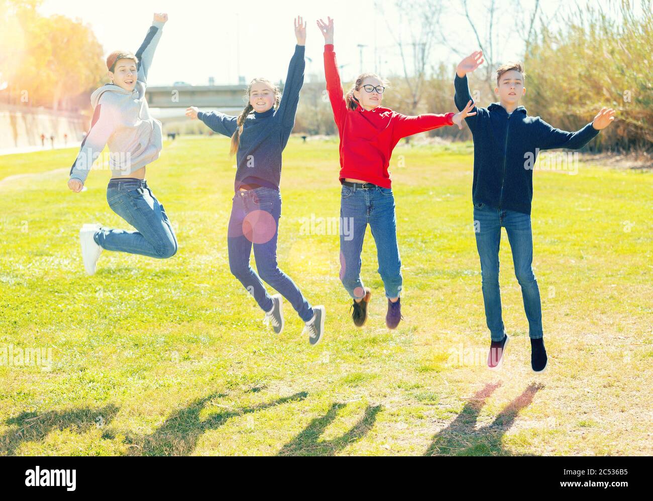 Portrait four happy friends jumping hi-res stock photography and images ...