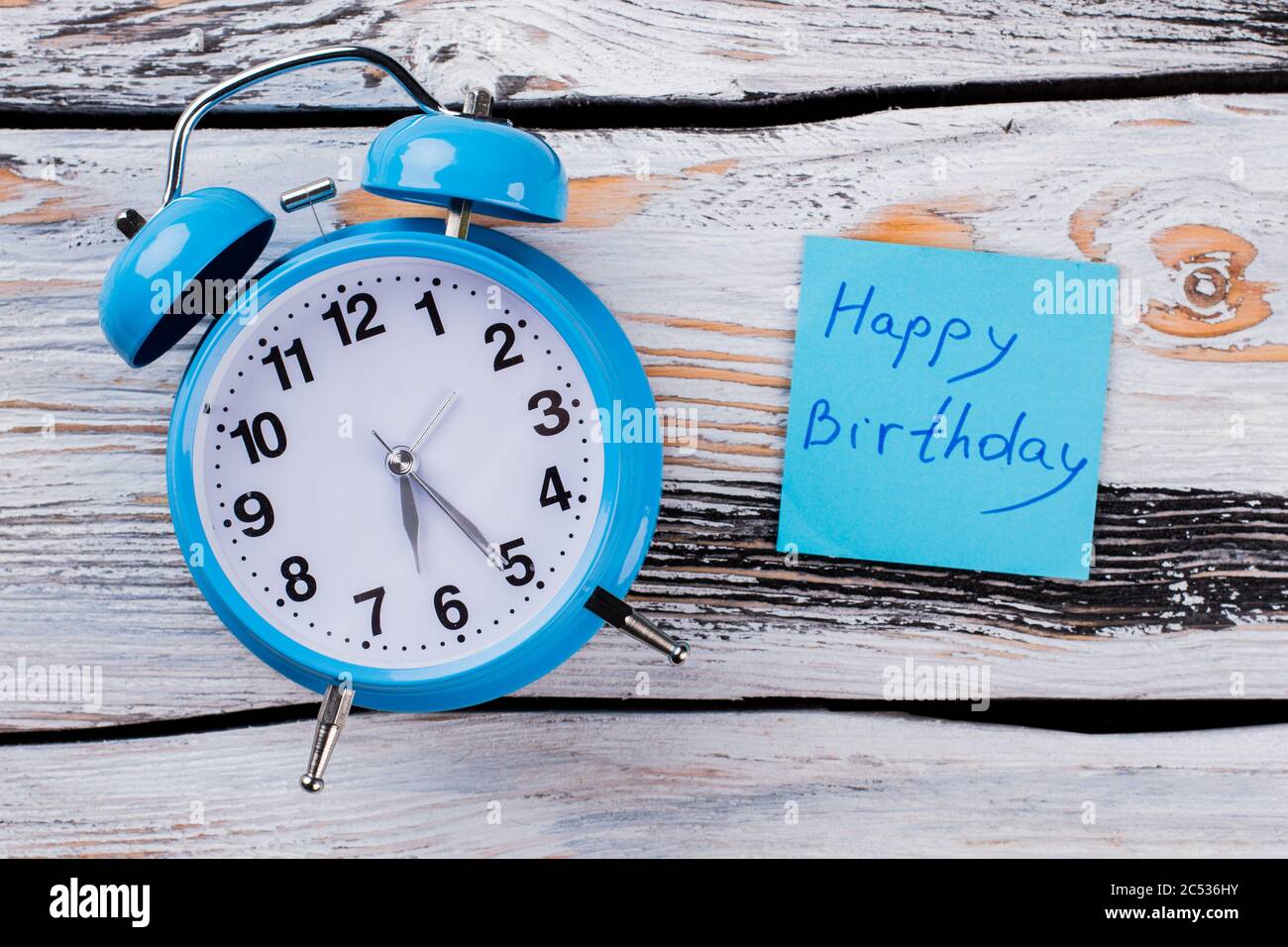 Blue vintage alarm clock and paper with happy birthday tagline Stock ...